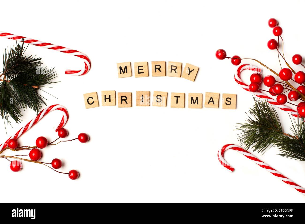 Merry christmas phrase made with wooden letter blocks, candy canes and ...