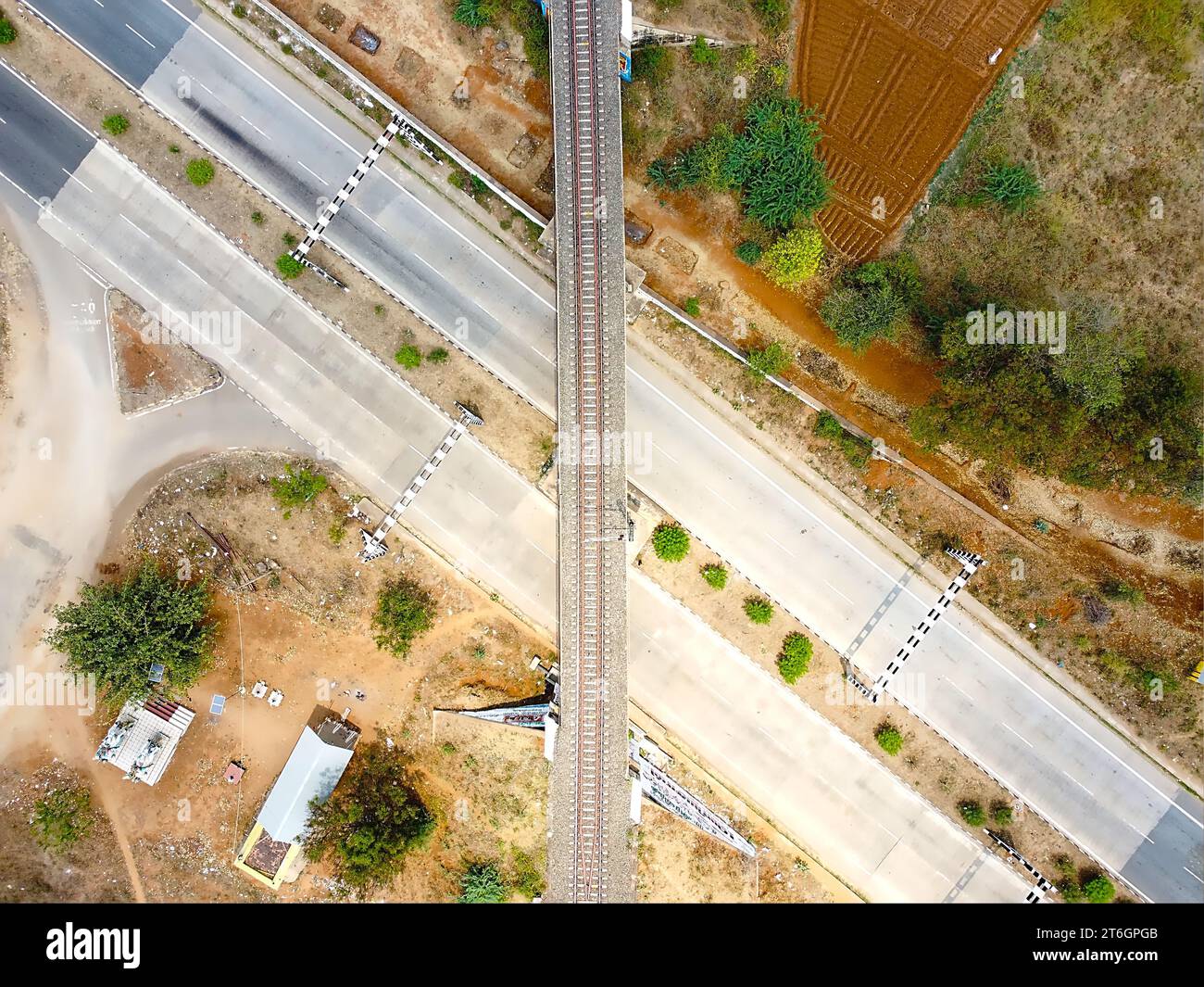 crossing of Railway track and highway roads Stock Photo - Alamy