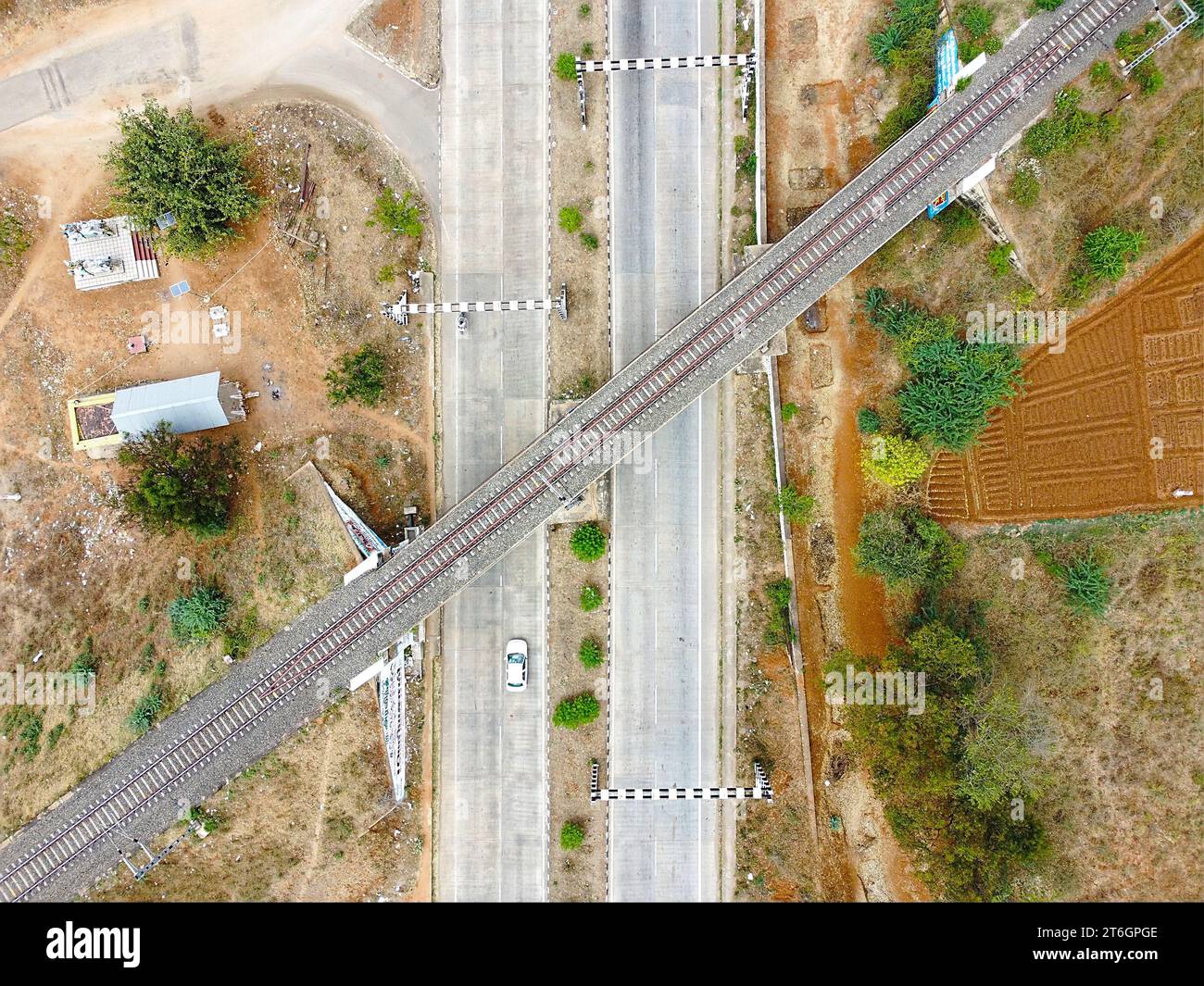 crossing of Railway track and highway roads Stock Photo - Alamy