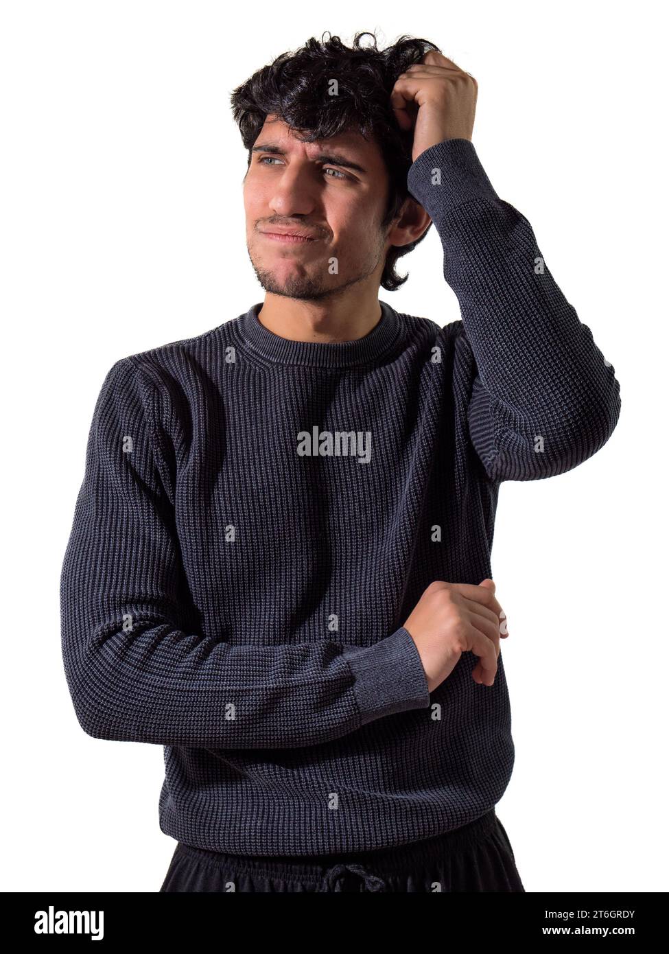 A young attractive man with curly hair is posing for a picture, with a ...