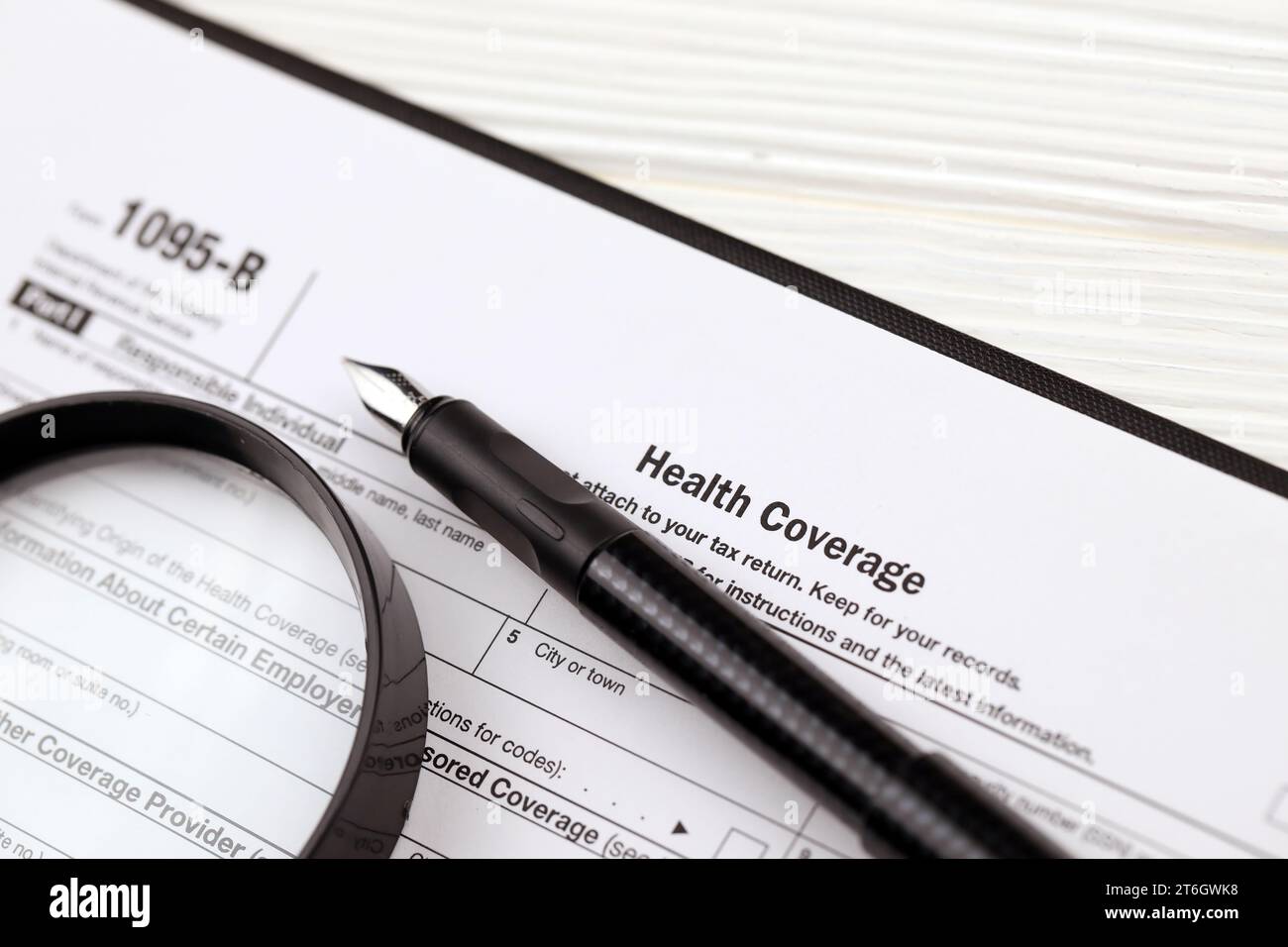 IRS Form 1095-B Health Coverage tax blank on A4 tablet lies on office ...