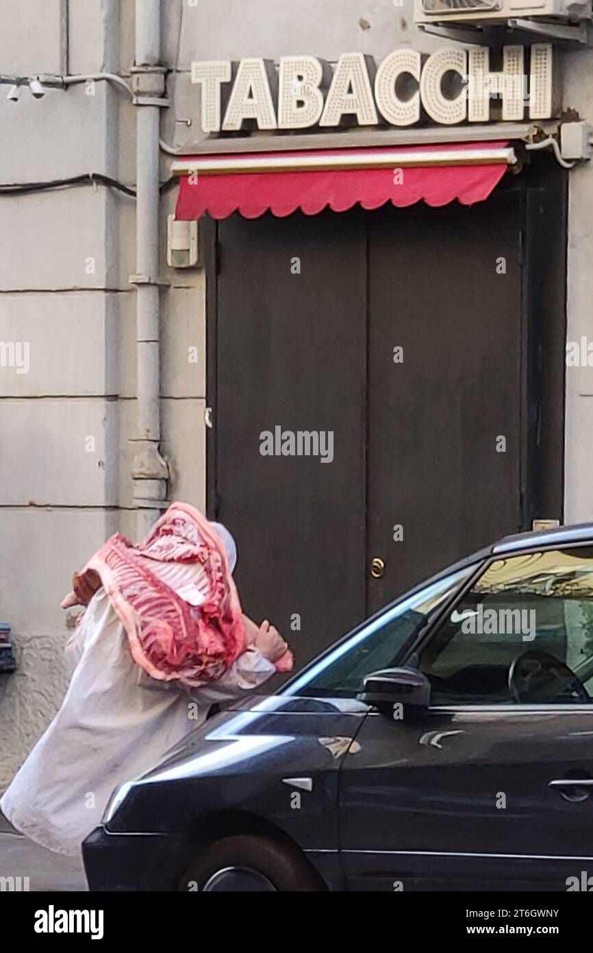 Meat arrives in the city center for the butcher shop, Two men unload ...