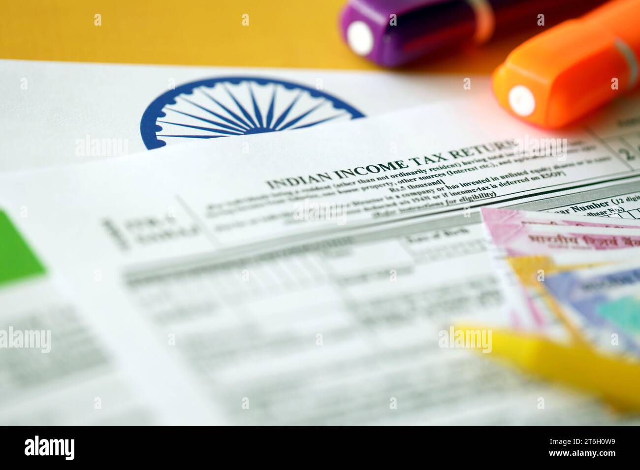 Indian income tax return blank form with pen and indian rupees bills on ...