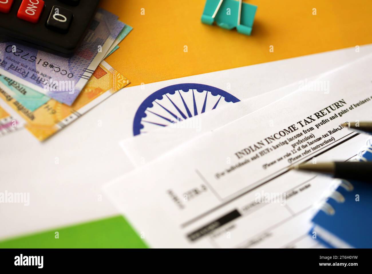Indian income tax return blank form with pen and indian rupees bills on ...