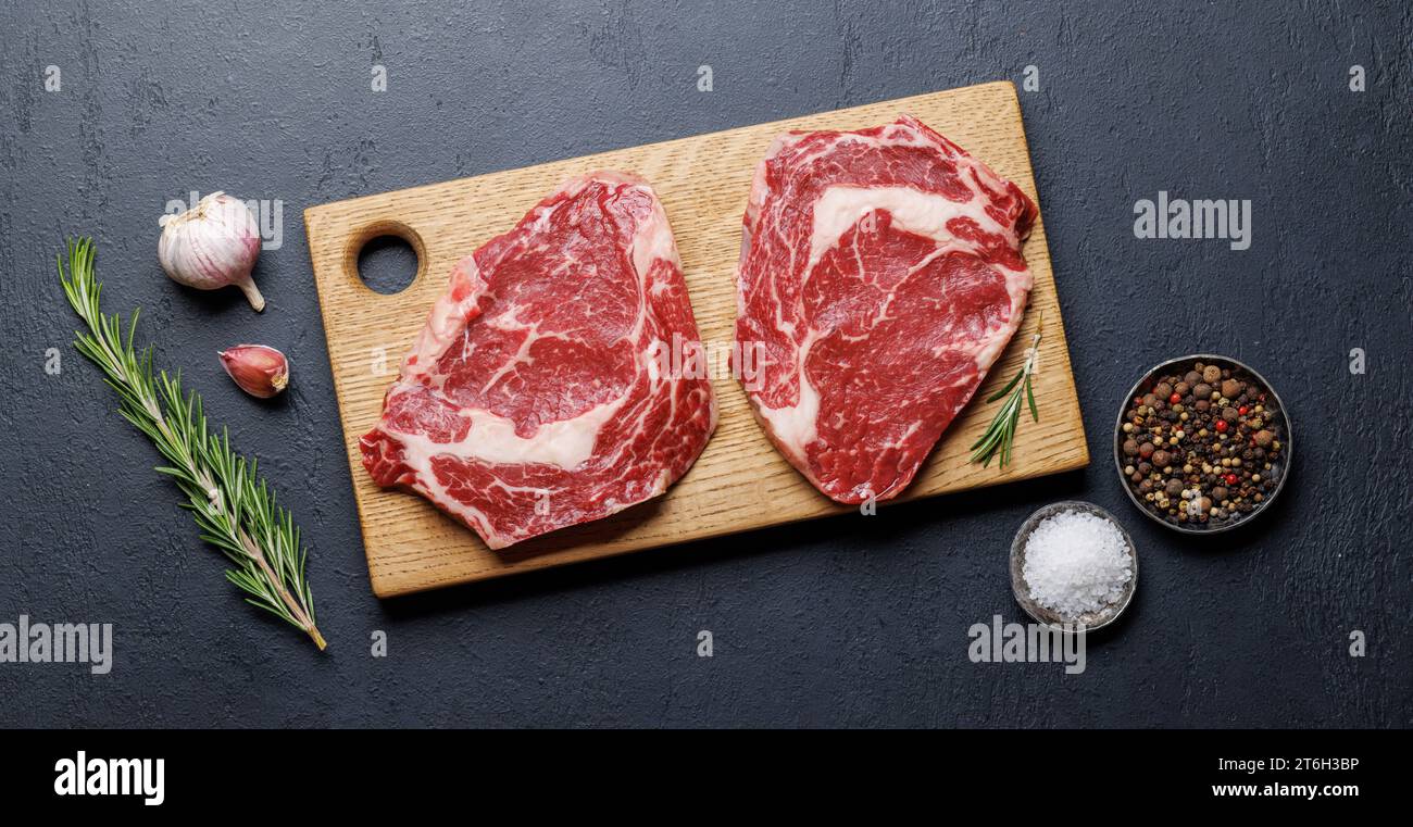 Raw ribeye steaks with savory spices. Flat lay Stock Photo - Alamy