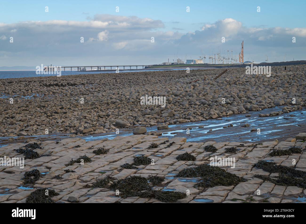 Hinkley Point construction site behind Limestone pavements and boulders ...