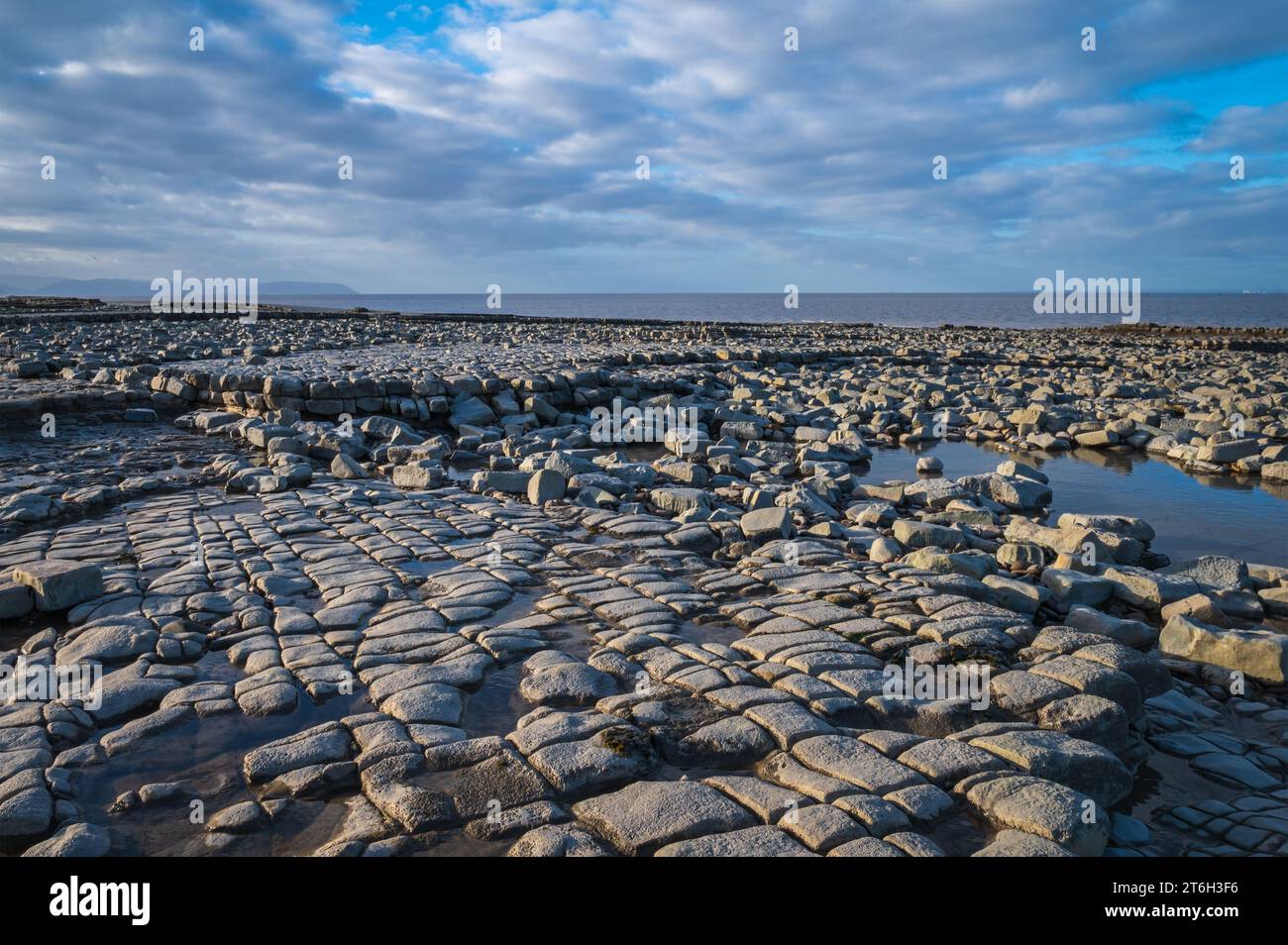 Limestone pavements and boulders exposed at low tide on Somerset Coast ...
