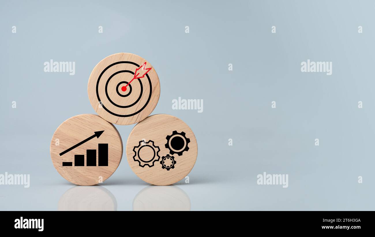 Circular wood with printed target icons and business symbols on white ...