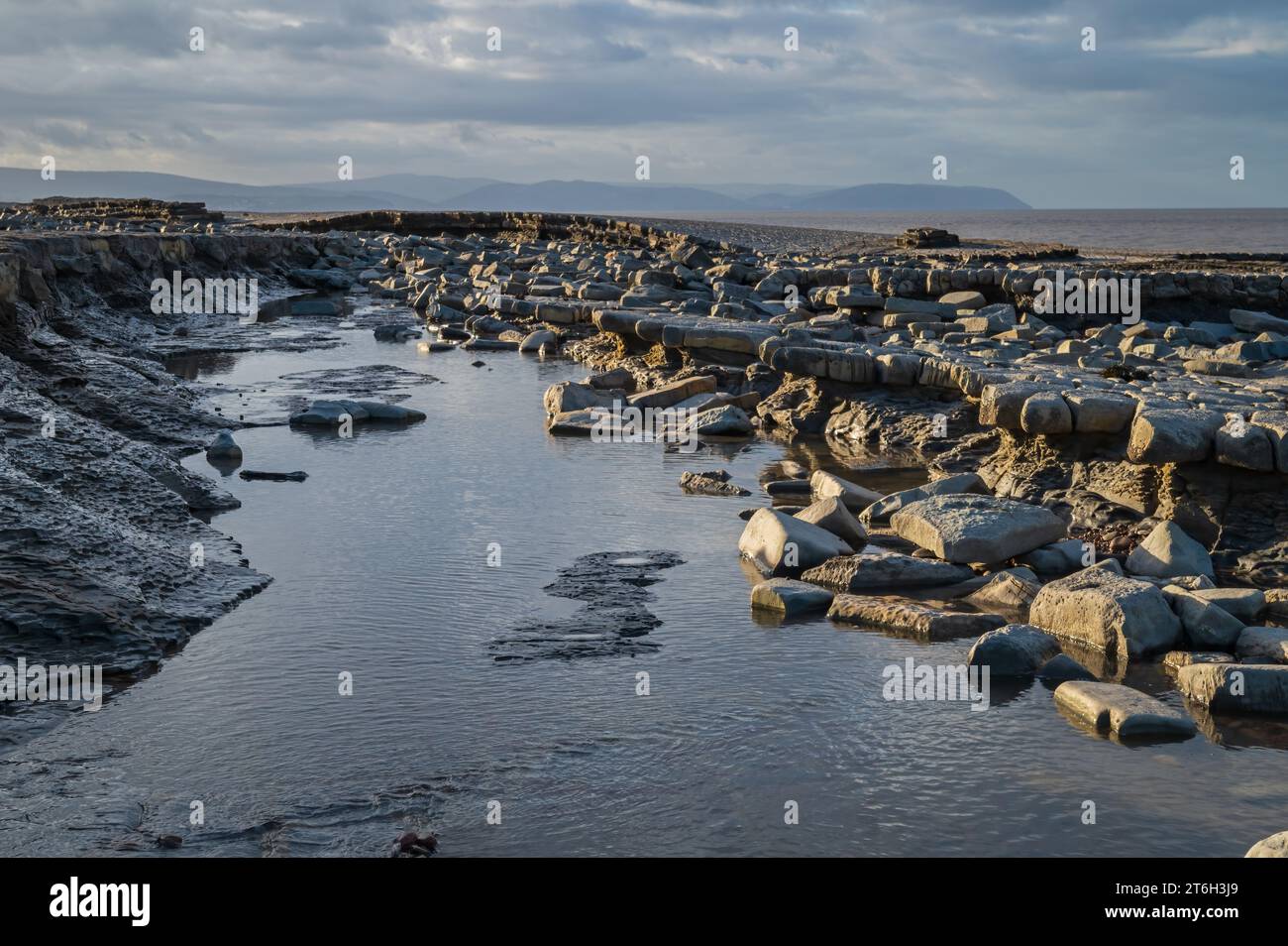 Limestone pavements and boulders exposed at low tide on Somerset Coast ...