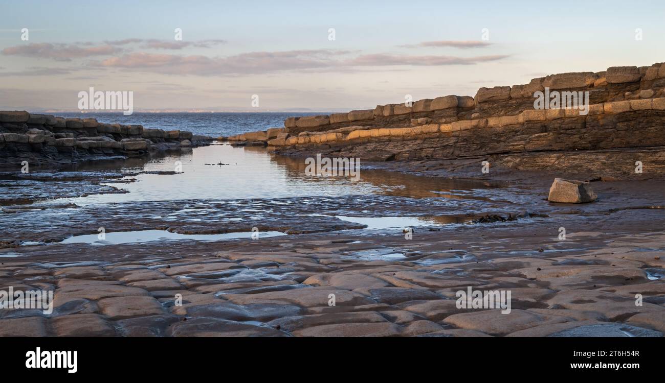Limestone pavements and boulders exposed at low tide on Somerset Coast ...