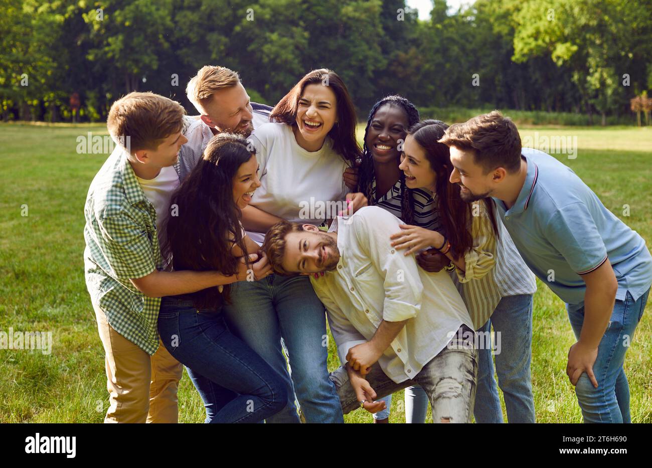 Funny happy overjoyed group of people friends having fun in nature on ...