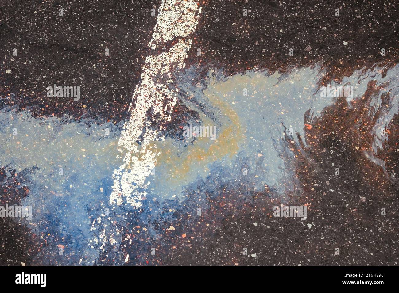 Oil spill on wet asphalt, parking lot with dividing line Stock Photo ...
