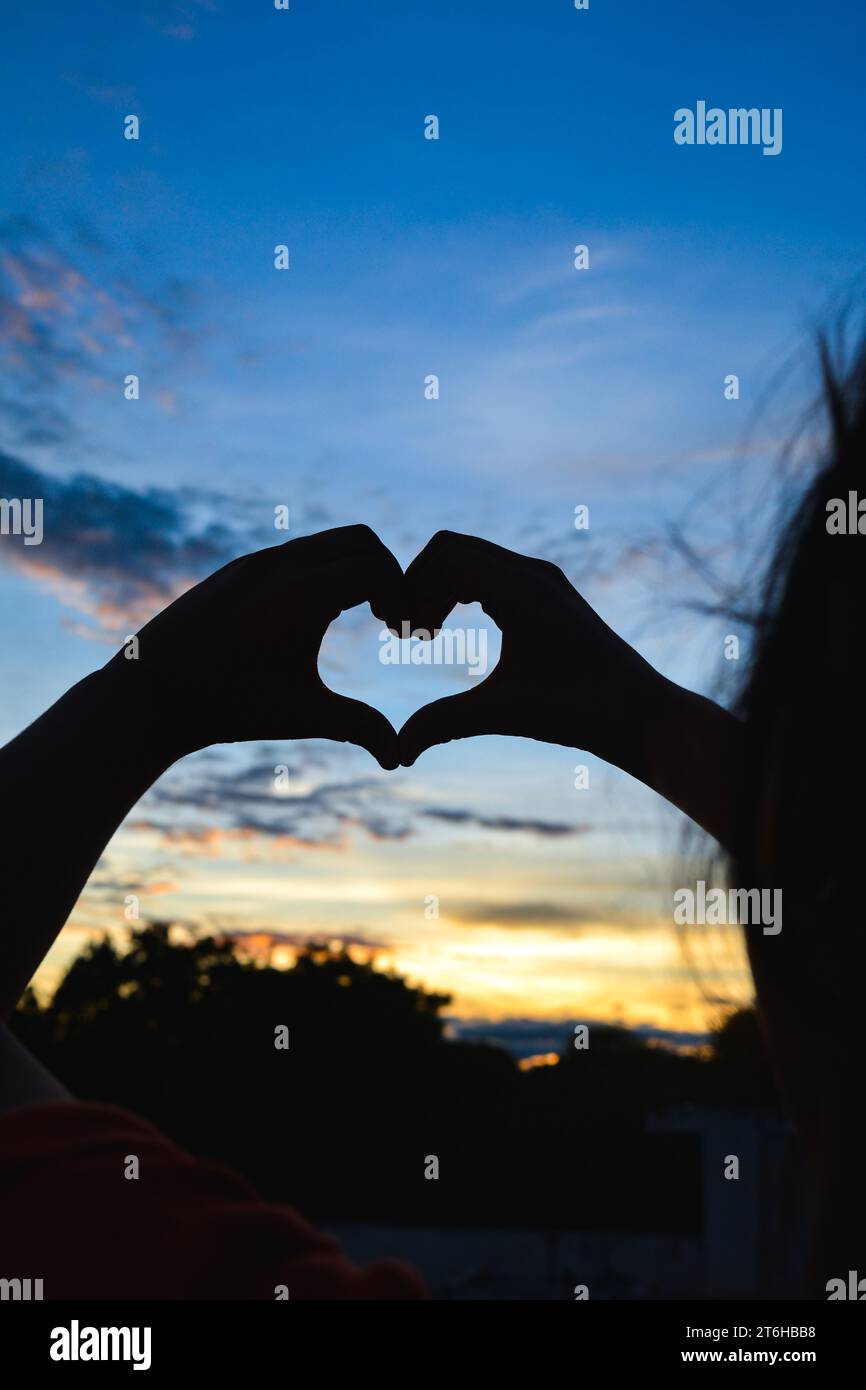 Hands forming a heart shape with sunset Stock Photo - Alamy