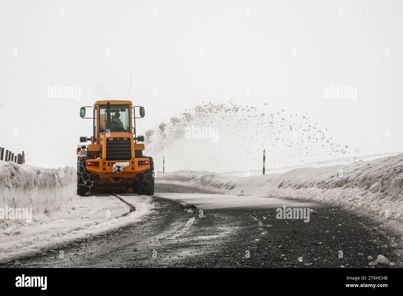 Snowplough clearing drifts from a moorland road, Northumberland ...