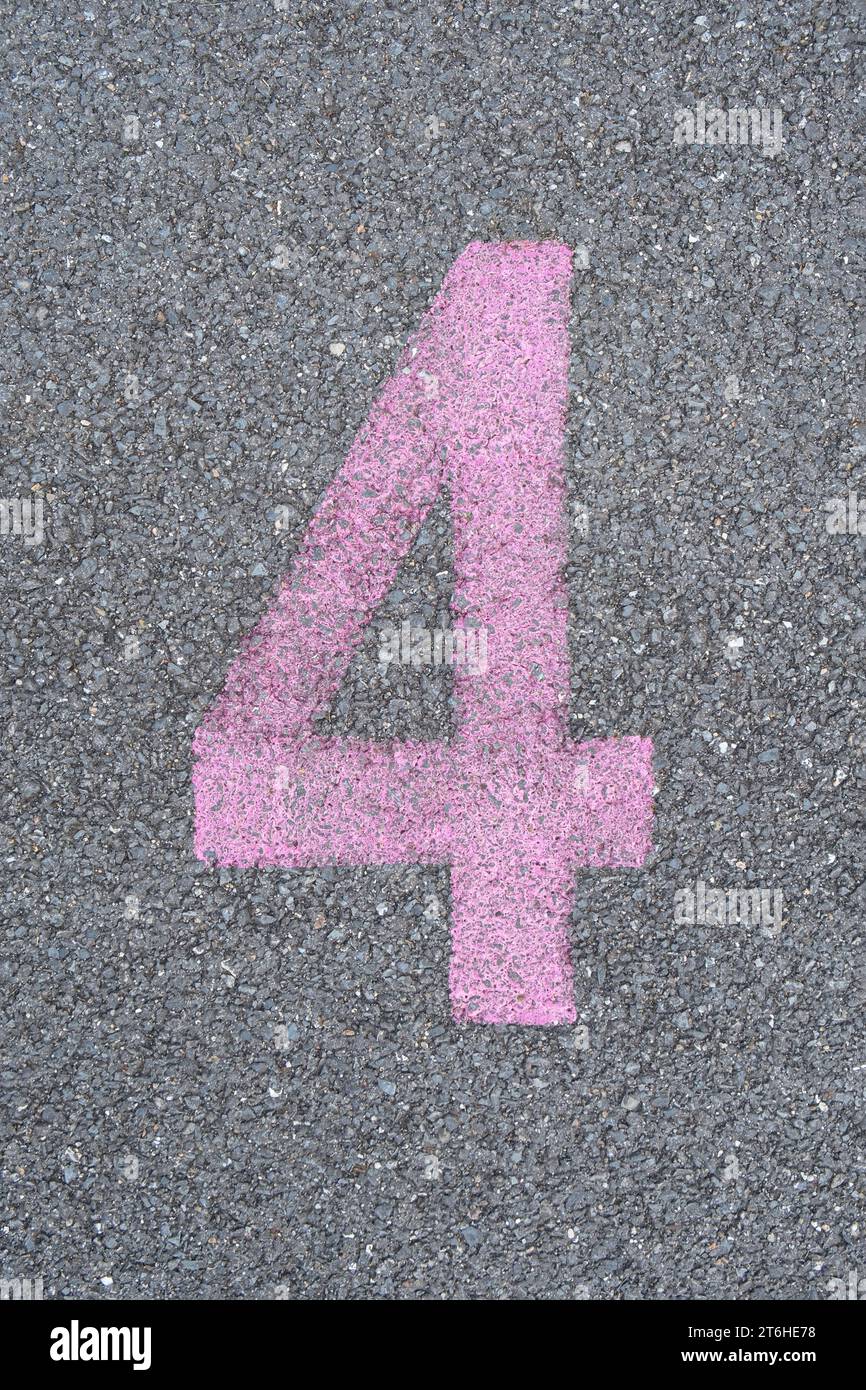 the number 4 four are drawn with color paint on asphalt. a children's ...