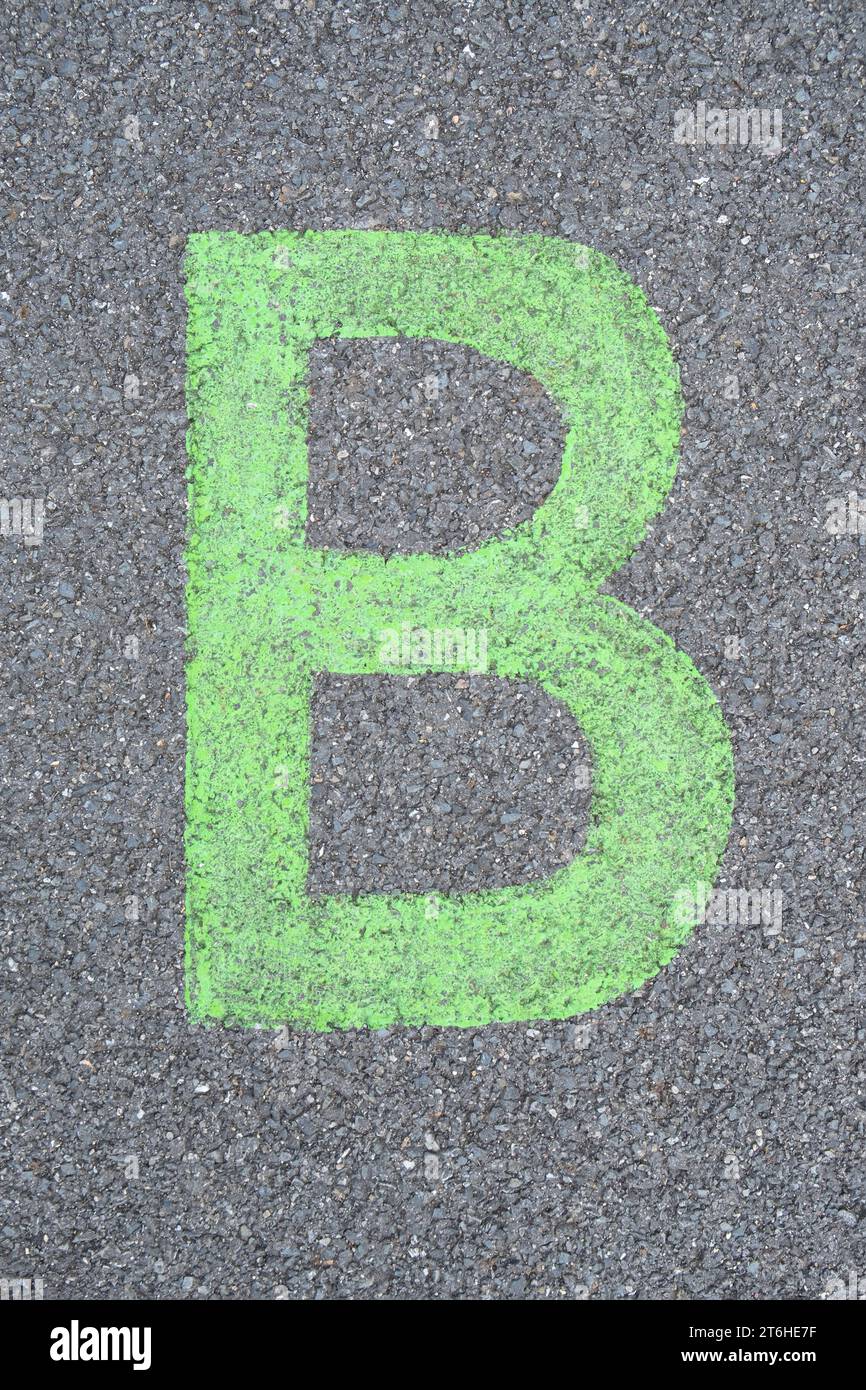 the Letter B are drawn with color paint on asphalt. a children's ...