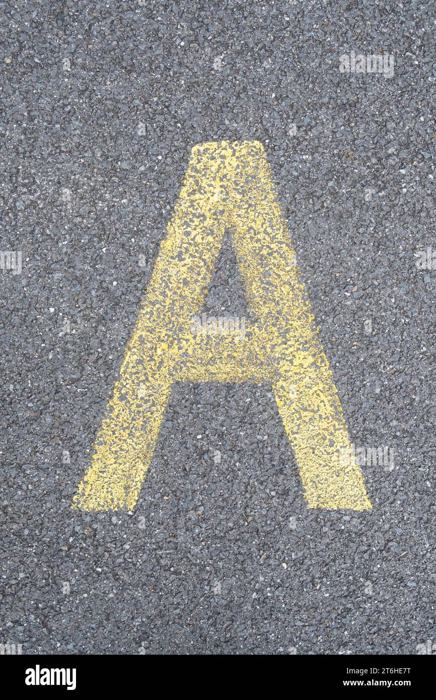 the Letter A are drawn with color paint on asphalt. a children's ...