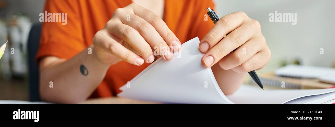 cropped view of young woman with tattoo in casual outfit turning ...