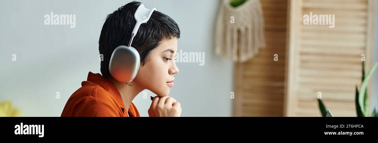 short haired student with headphones studying attentively during online ...