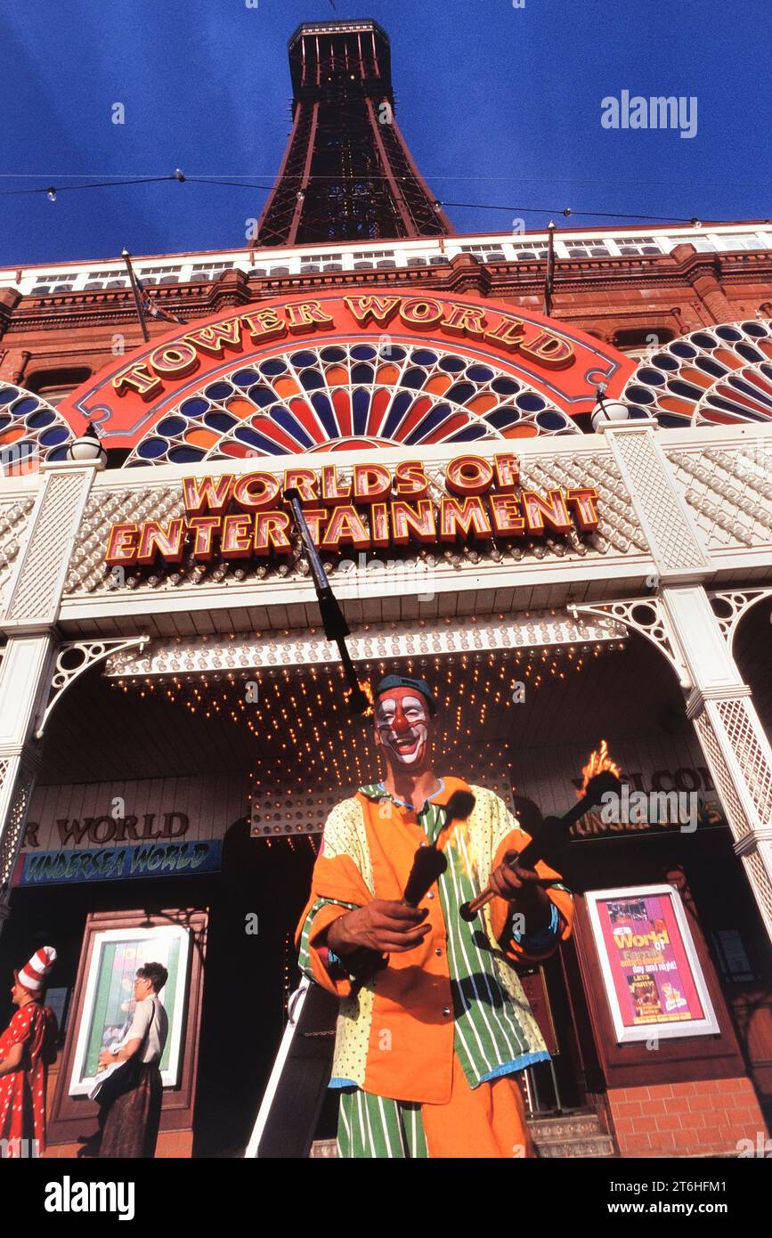 A clown juggling fire torches outside Blackpool Tower, Lancashire ...