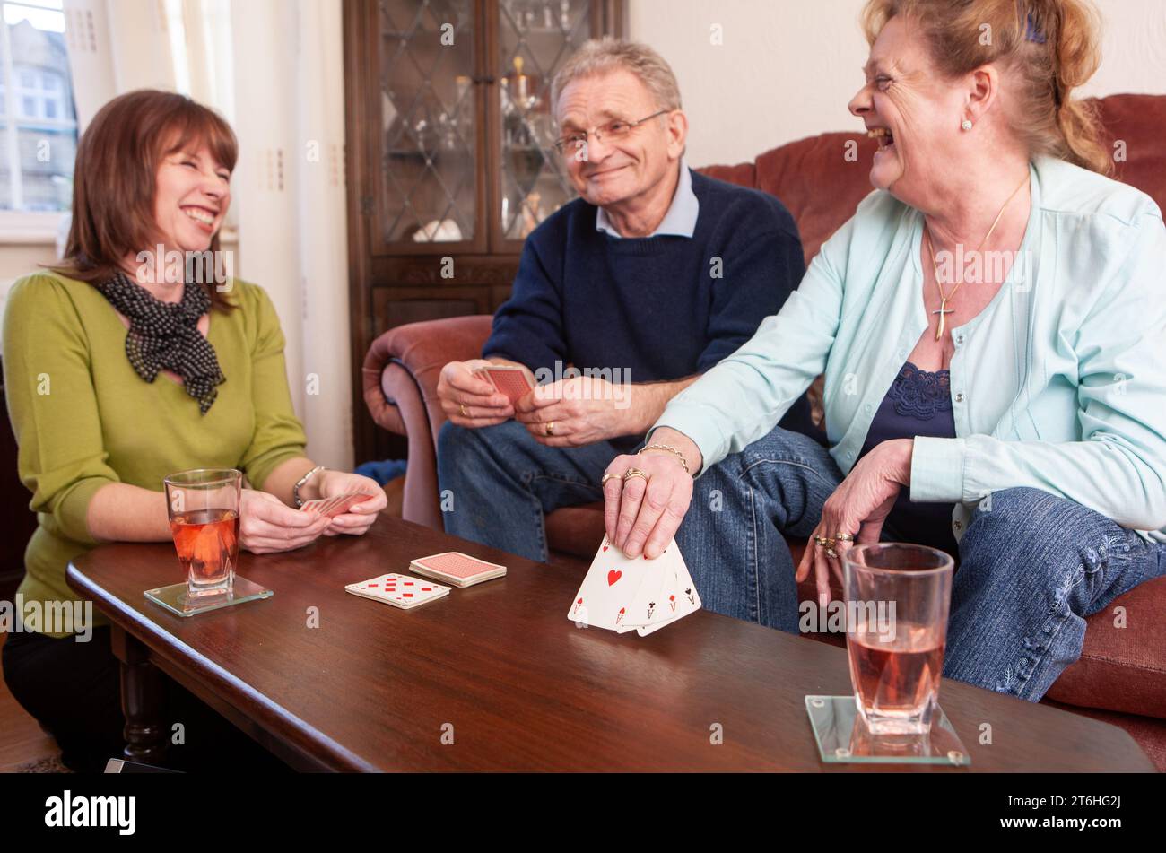 Help the Aged: FAmily Games. A mature woman visiting her aging parents ...