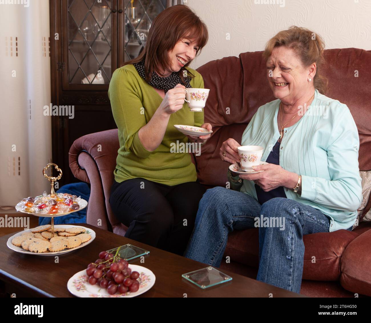 Help the Aged: Tea with Mother. A mature woman visiting her aging ...
