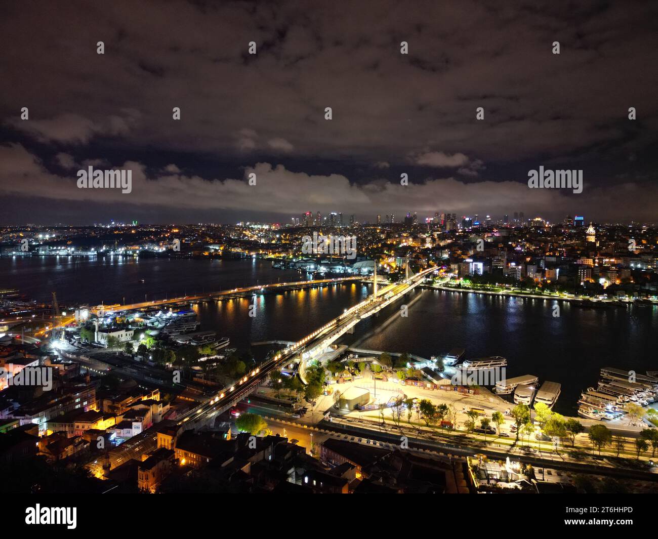 An aerial view of a city skyline illuminated by the night's stars, with ...