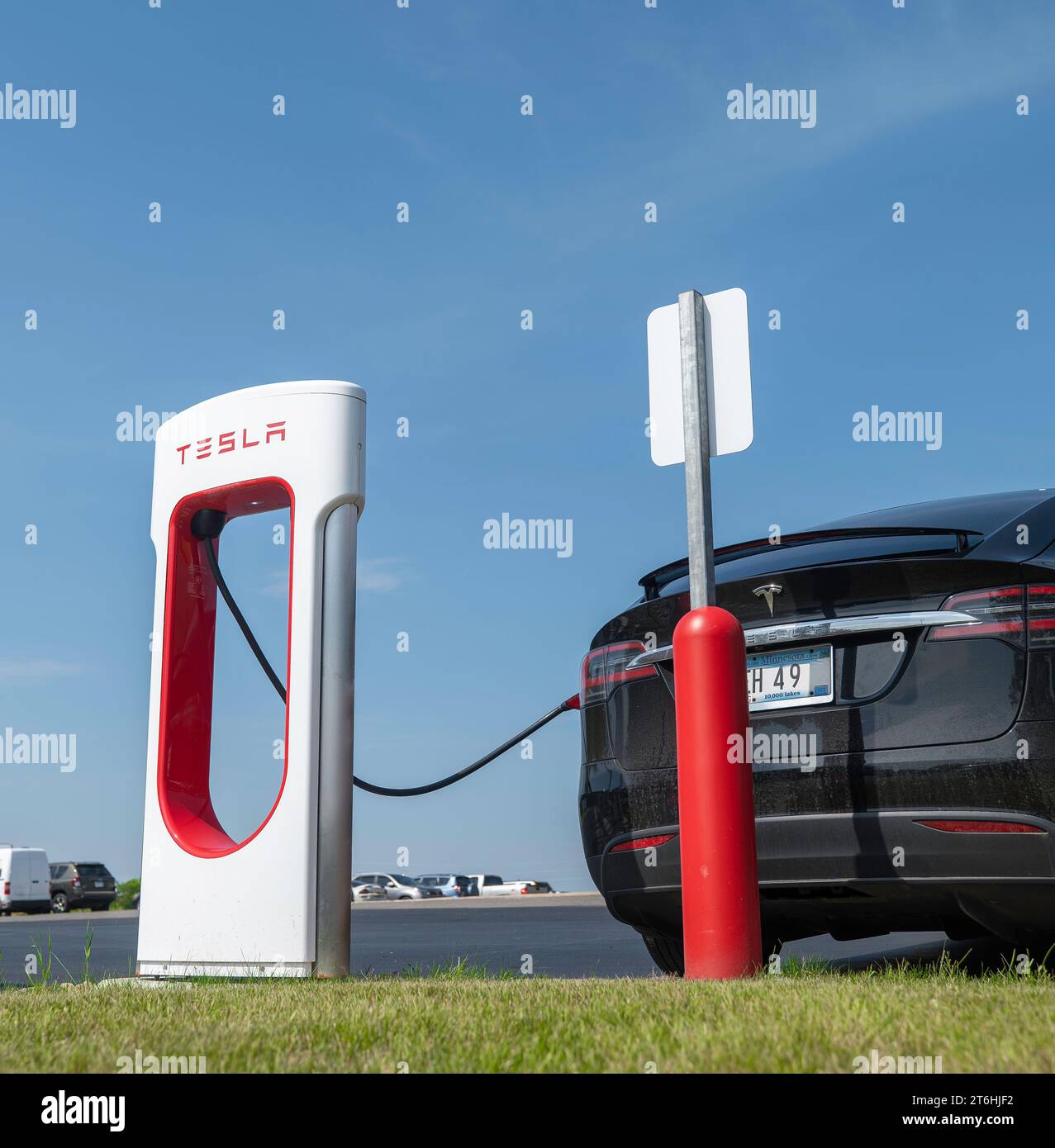 BEMIDJI, MN – 3 JUN 2023: Black Tesla Electric Vehicle car connected by ...