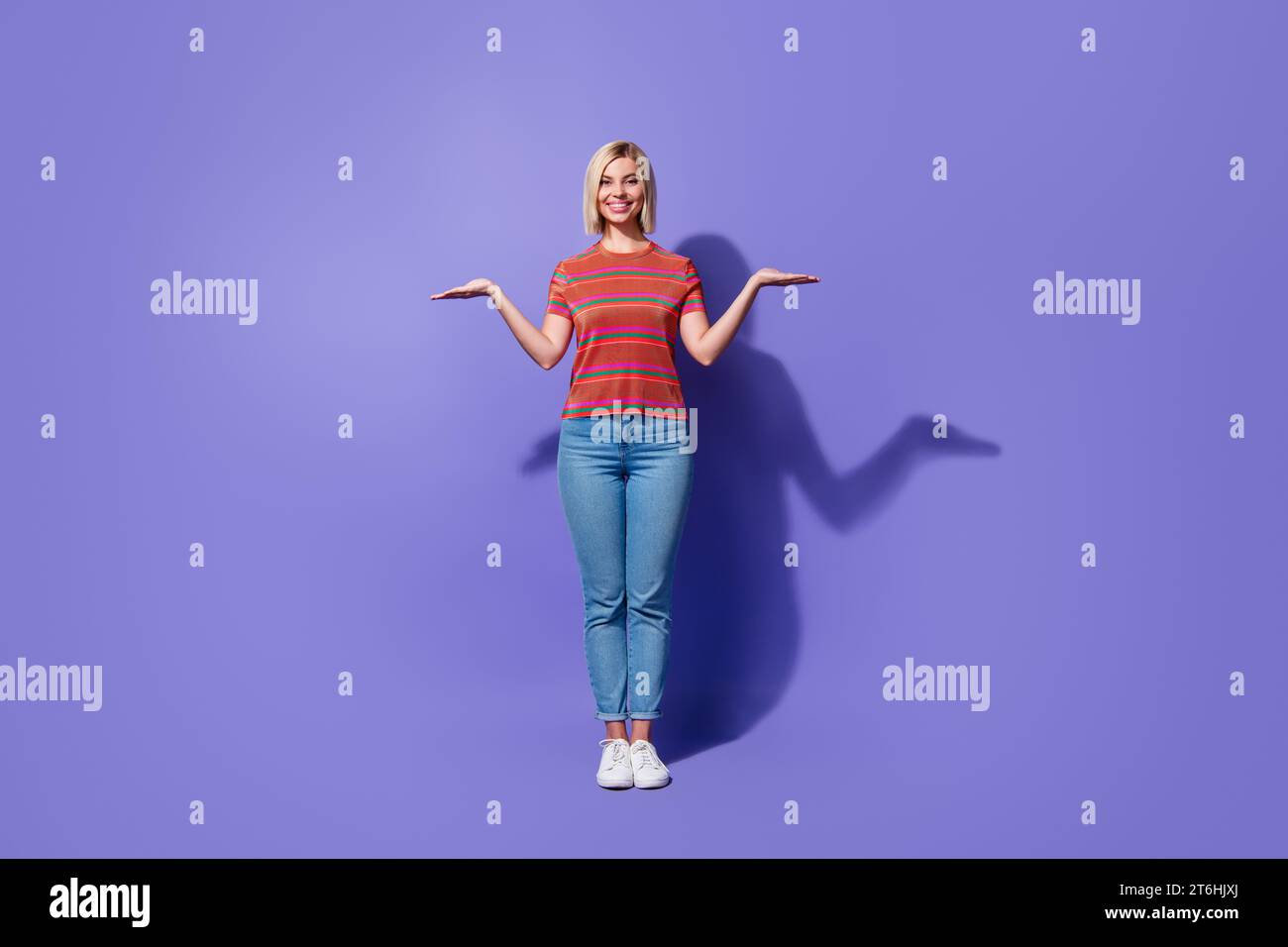 Full size body photo of young friendly promoter girl hold two palms ...