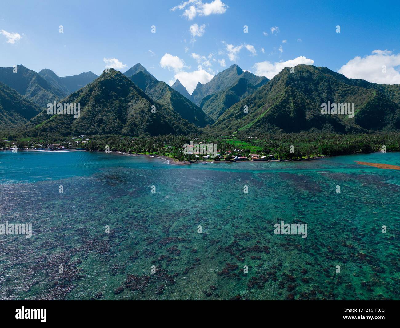 Teahupo'o surfing destination, tahiti, with mountains in the background ...