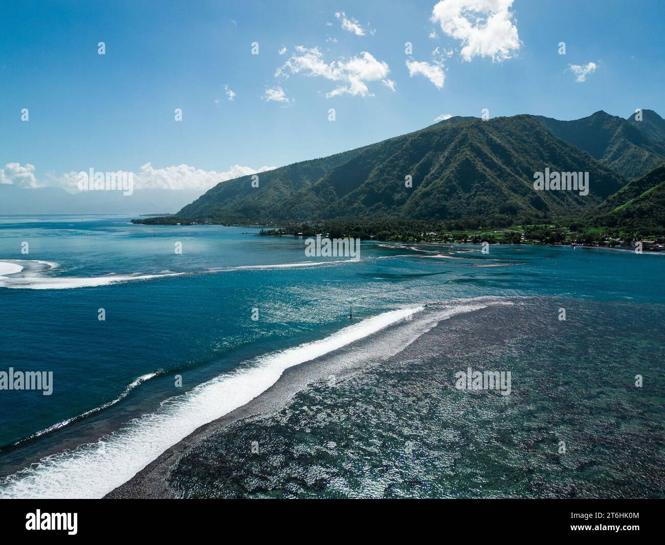 Teahupo'o surfing destination, tahiti, with mountains in the background ...
