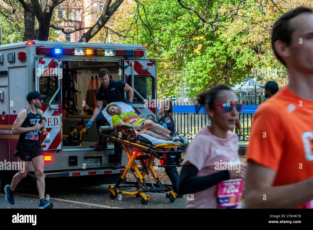 EMT’s load a runner into their ambulance as runners pass through Harlem ...