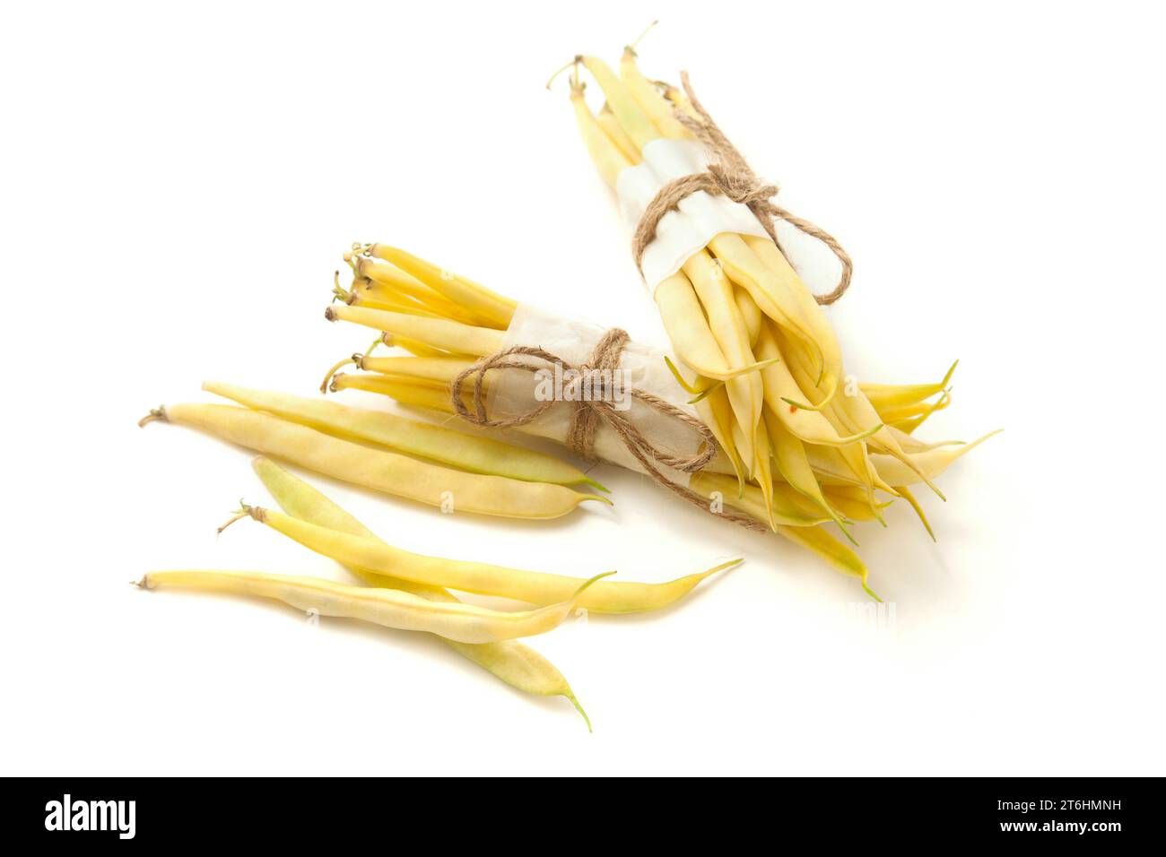 Two bunches and small pile of raw yellow pods of haricot isolated on ...