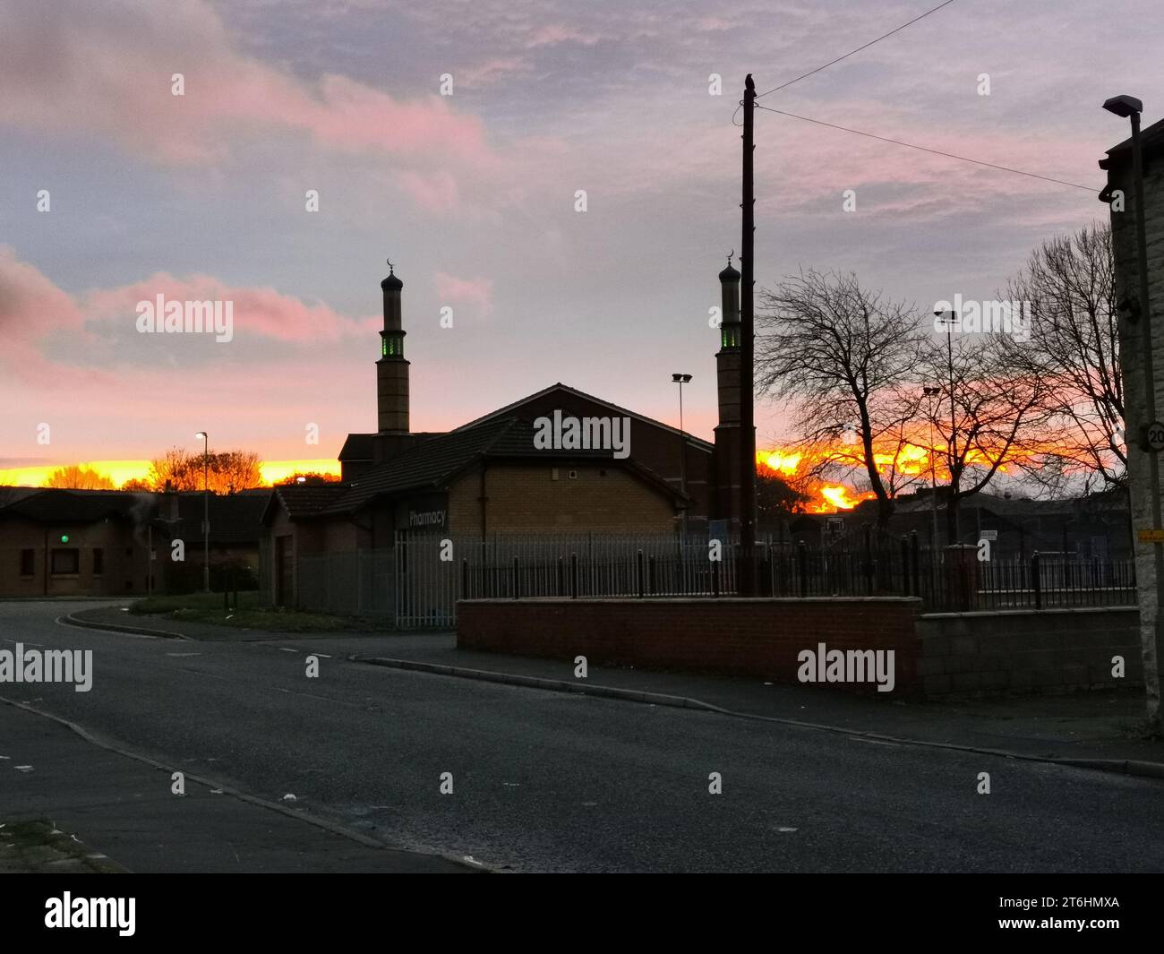 A tranquil scene of a street corner illuminated by the golden rays of ...