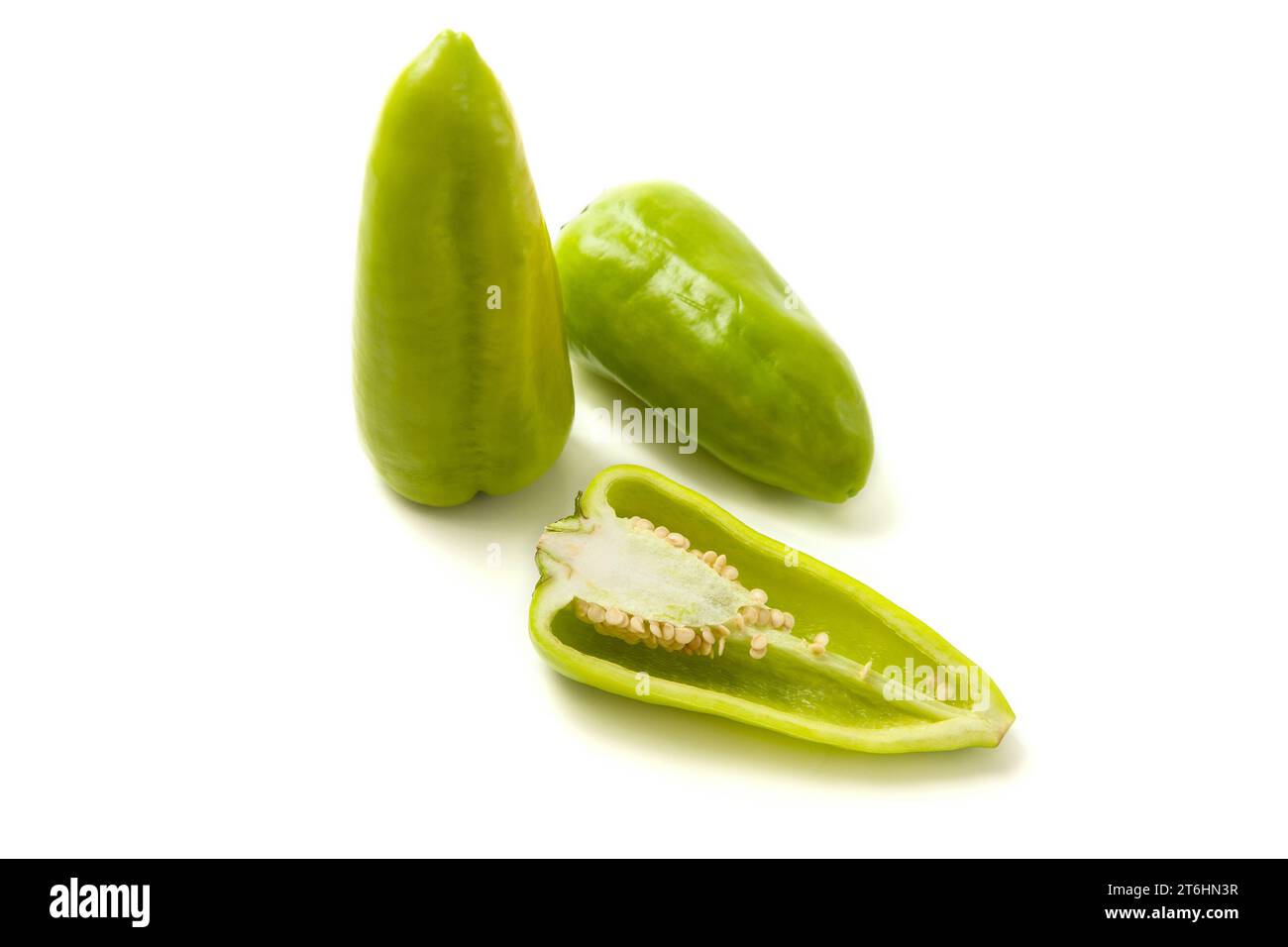 Two whole and half of green bell pepper (capsicum) known as sweet bell ...