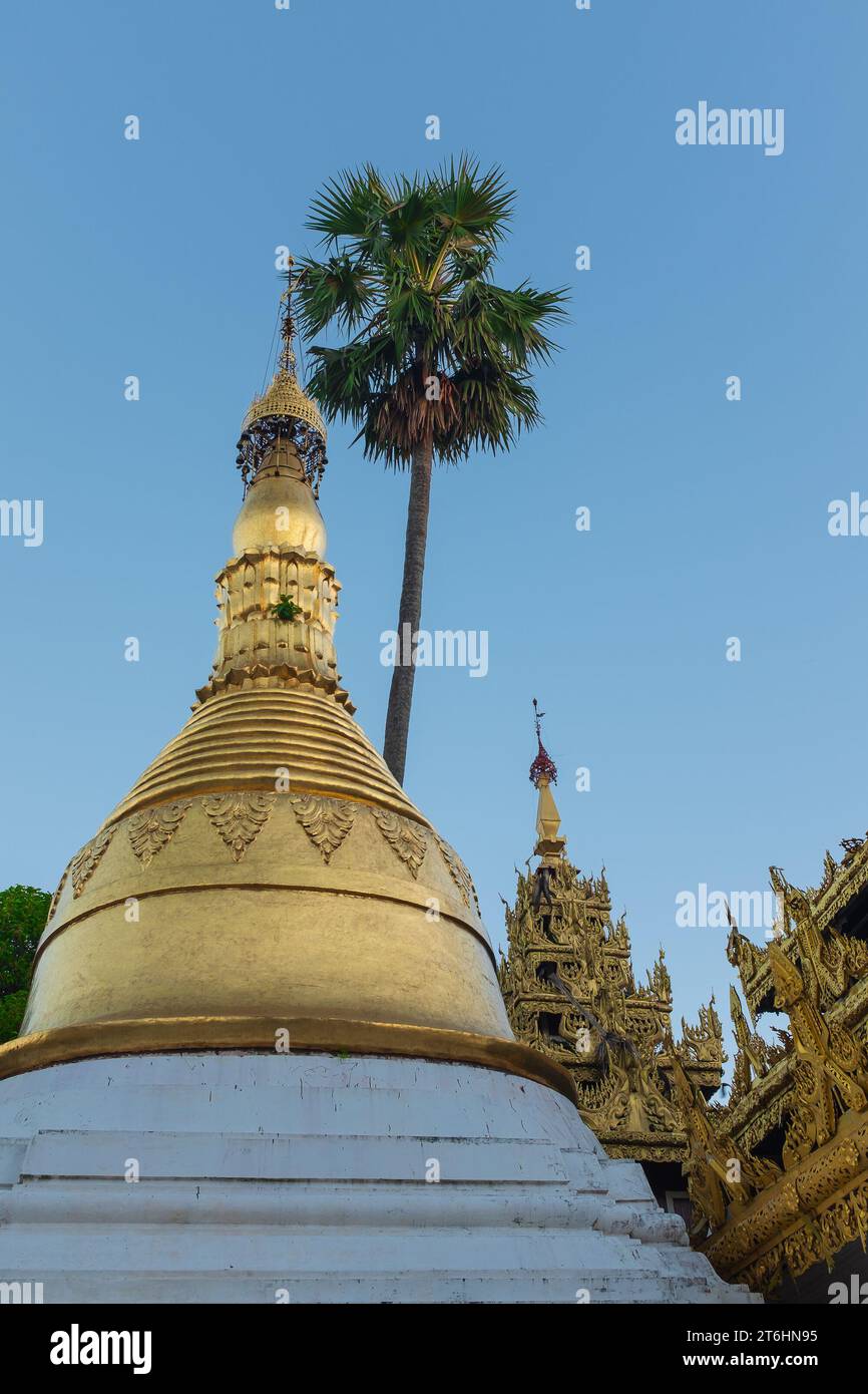 Yangon, Myanmar. On the Shwedagon Pagoda platform at daybreak, a gold-leaf covered stupa stands ...