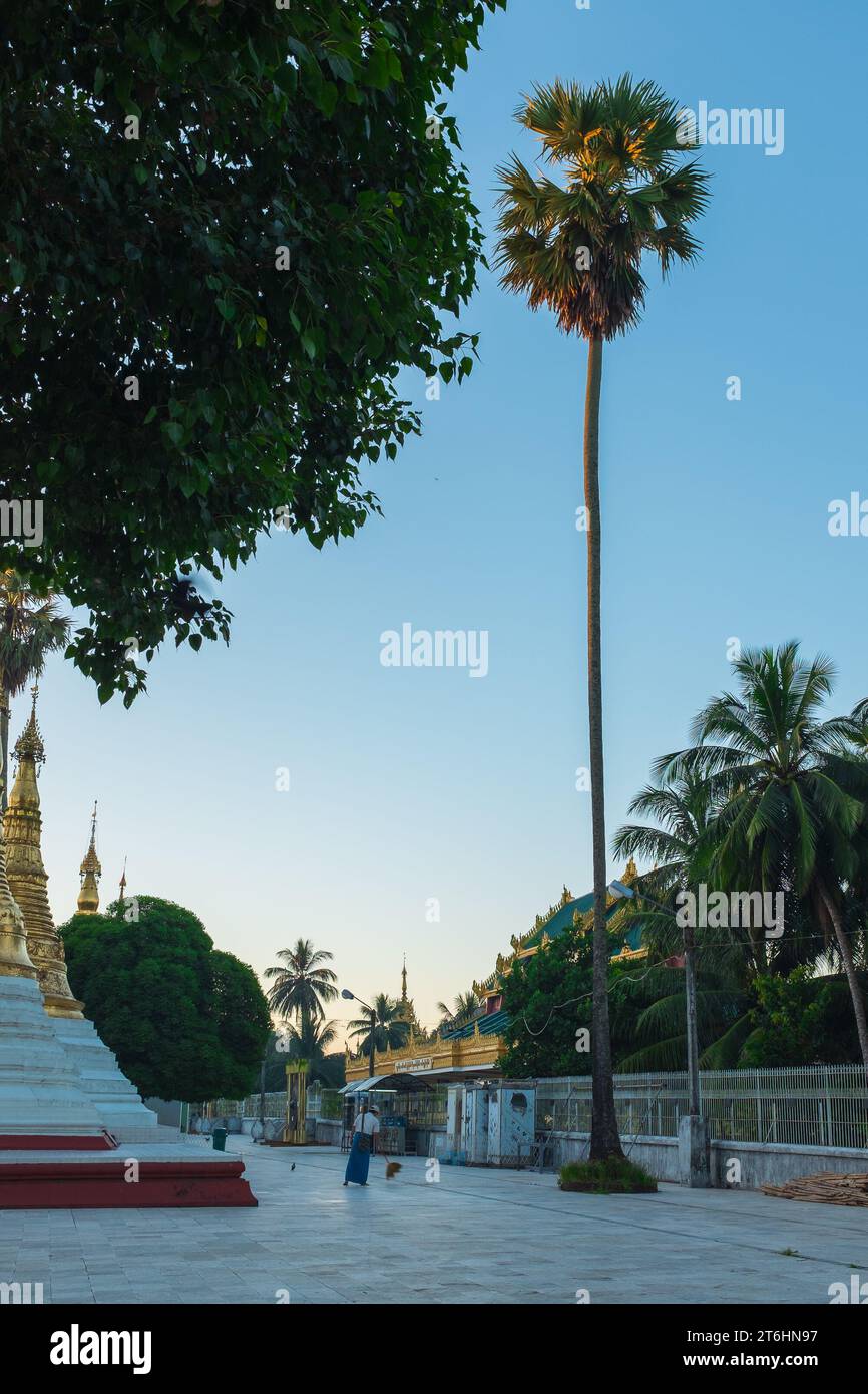 Yangon, Myanmar. On the Shwedagon Pagoda Platform, a man is sweeping ...