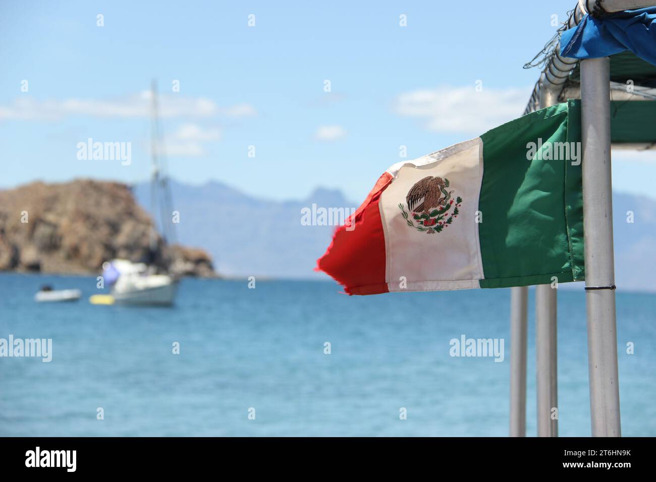 An aerial shot of a Mexican flag floating in the water, with the ...