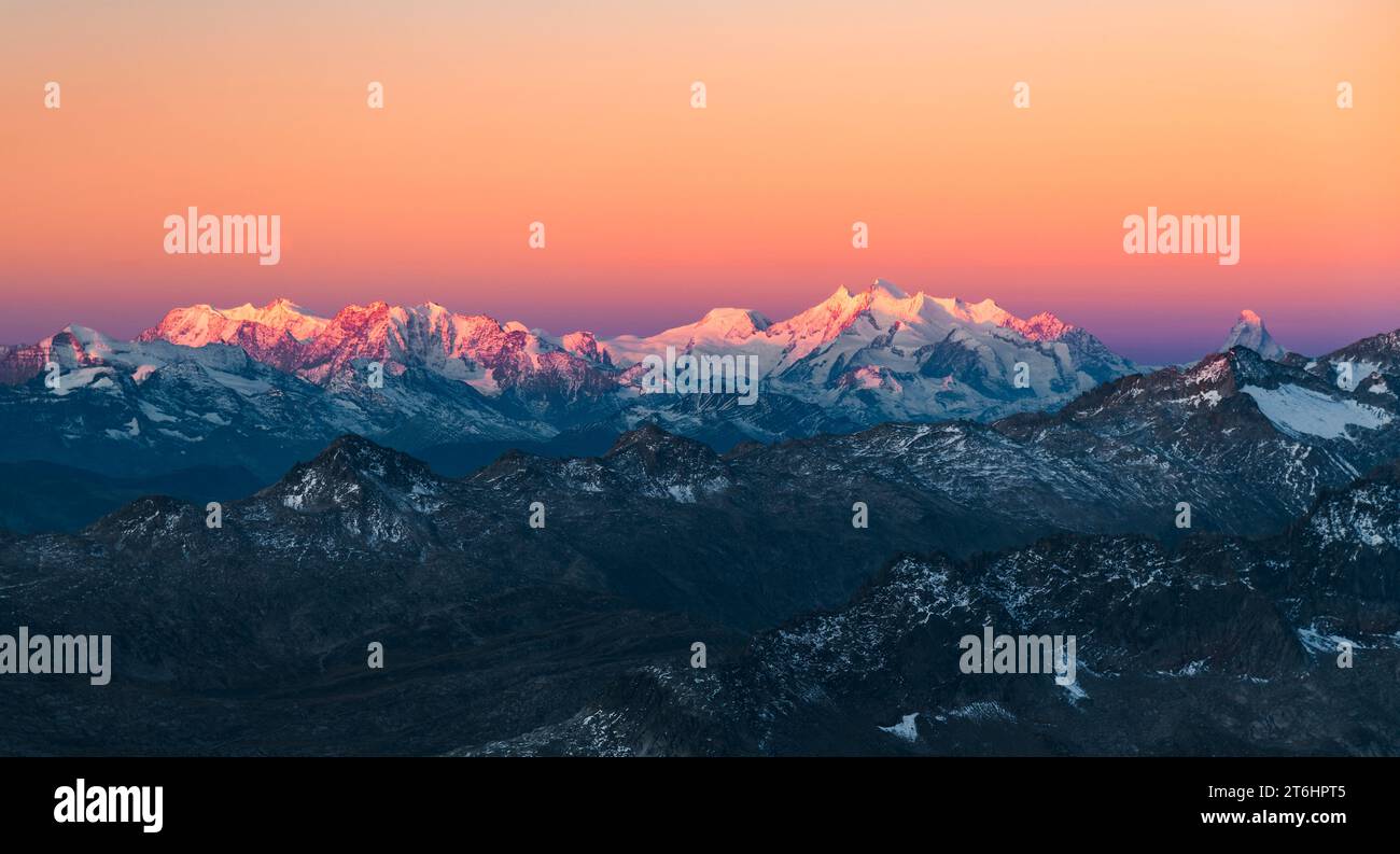 Colorful sunrise over the Valais Alps in summer. From left Monte Rosa ...