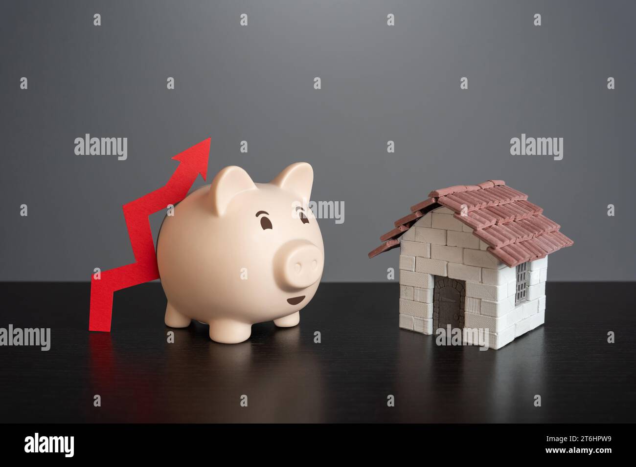 Pig piggy bank with a red arrow up and a house. Rising housing prices ...