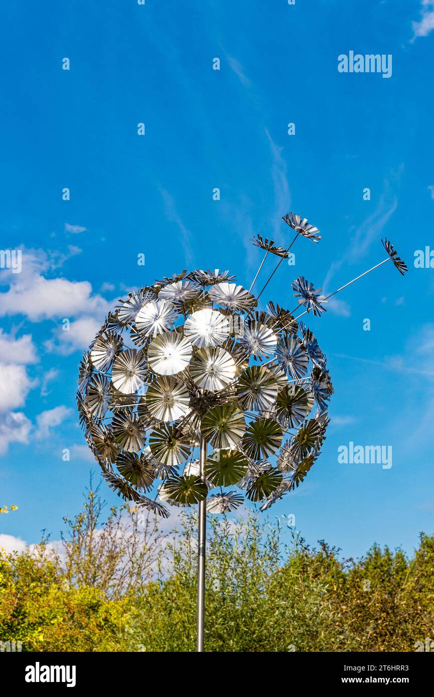 highly reflective stainless steel artwork, depicting a "puffball ...