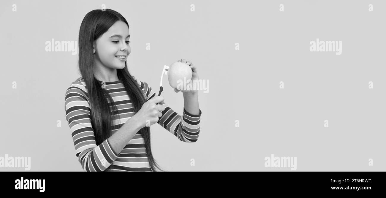 Brush it up. Happy child brush apple with toothbrush. Dental care ...