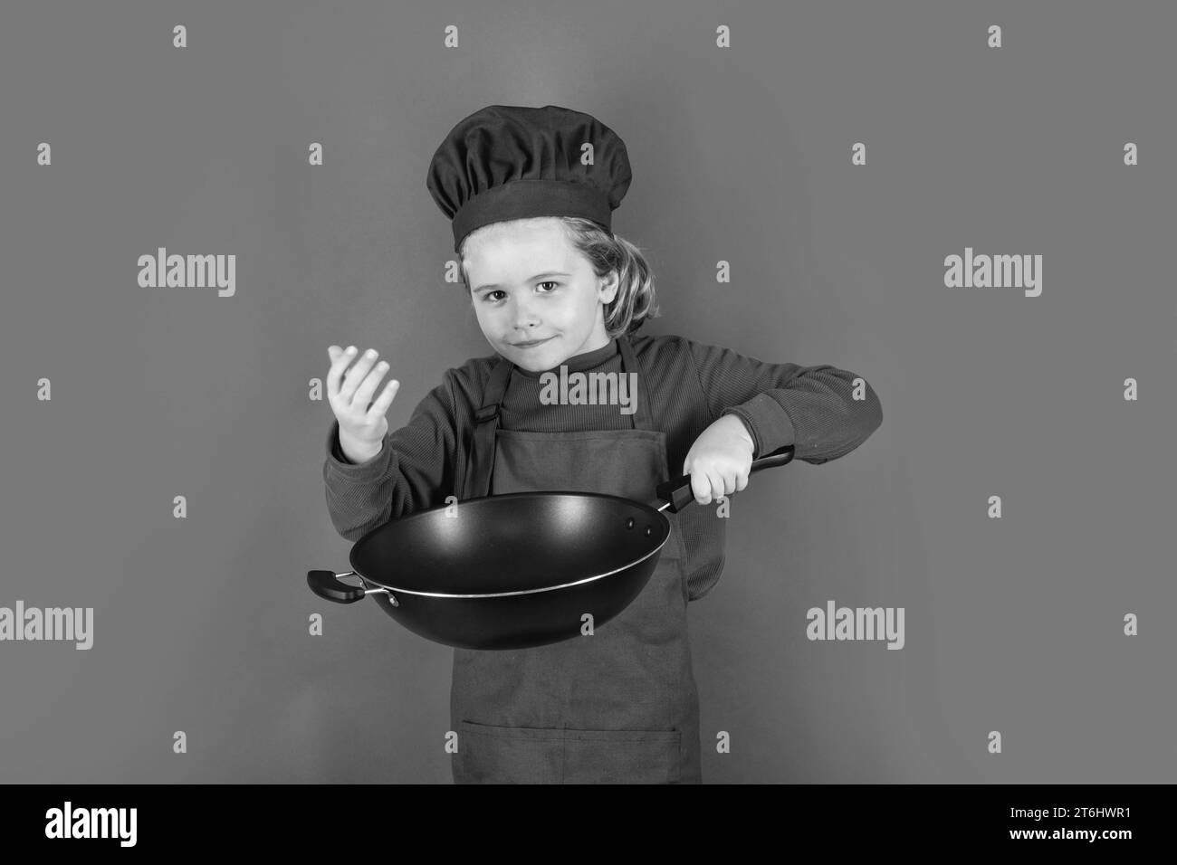Kid cook with cooking pan. Chef kid preparing healthy food. Portrait of ...