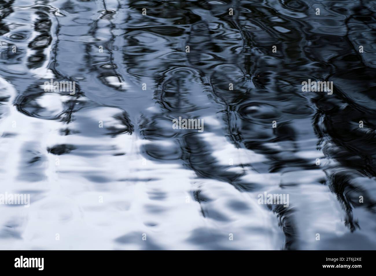 small waves, light reflexes and reflections on the water surface of a ...