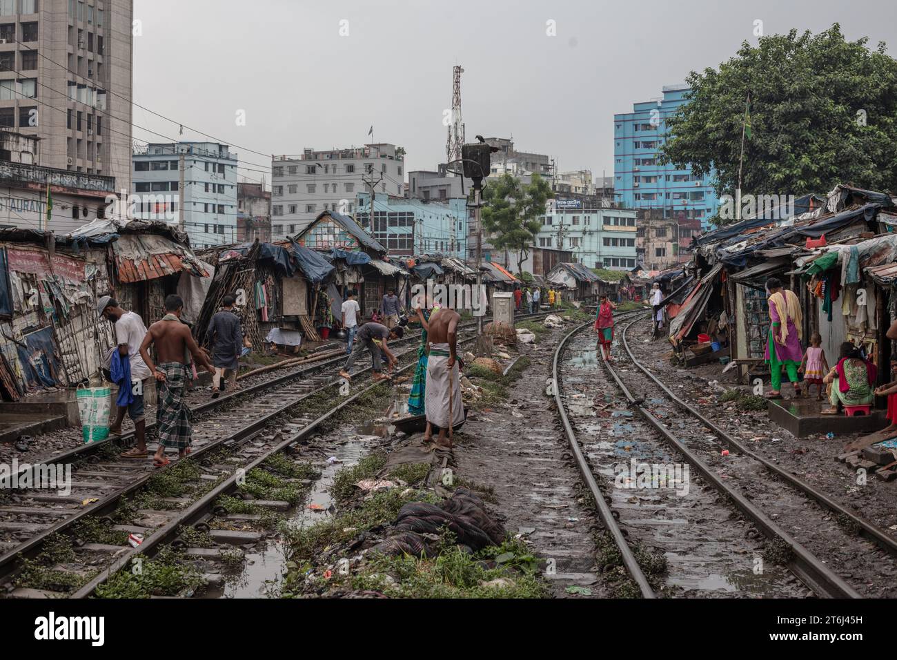 Father with his son walking on the railway tracks, Tejgaon Slum Area ...