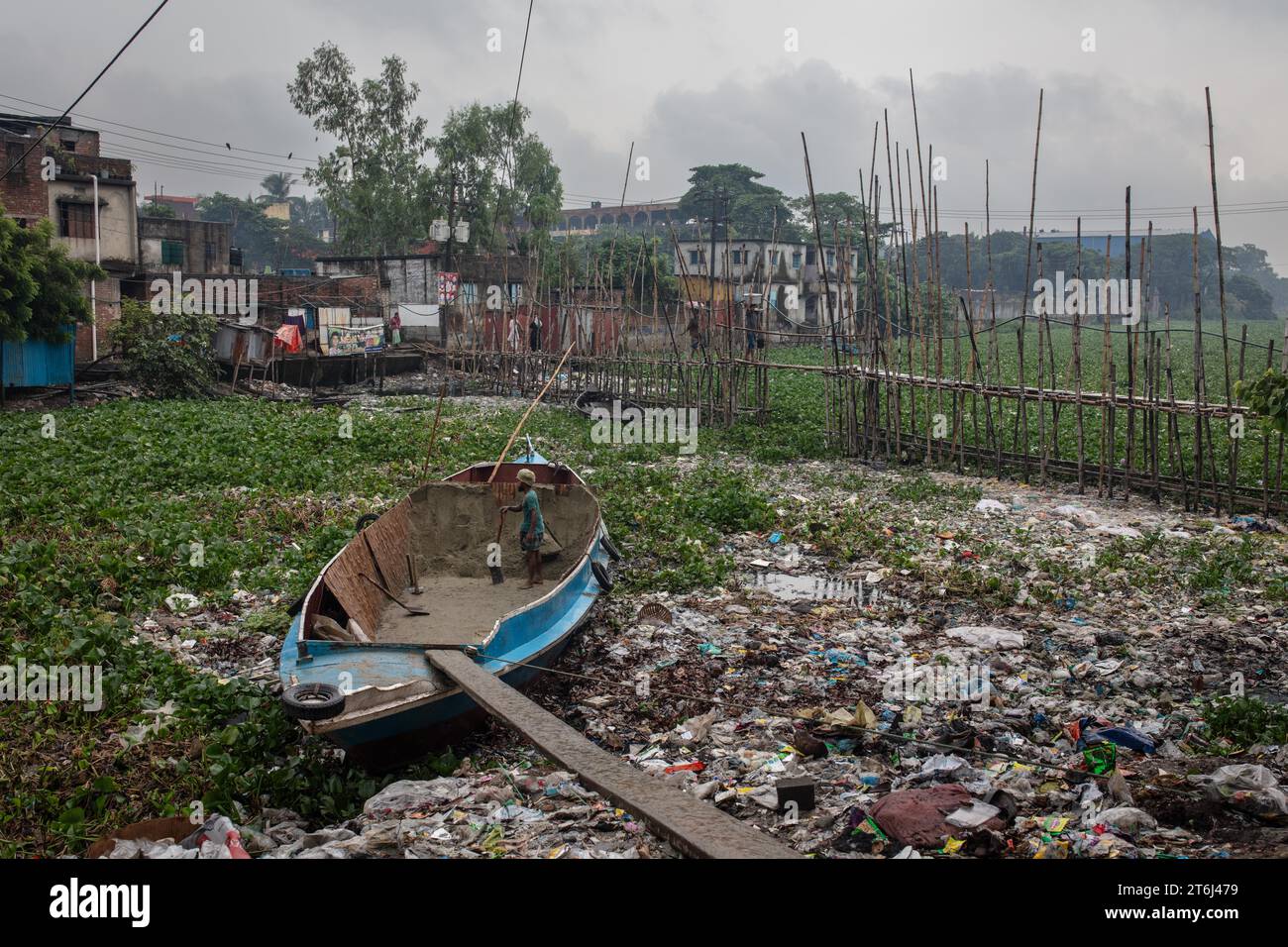Construction workers transporting sand from a boat over a plank, Tel ...