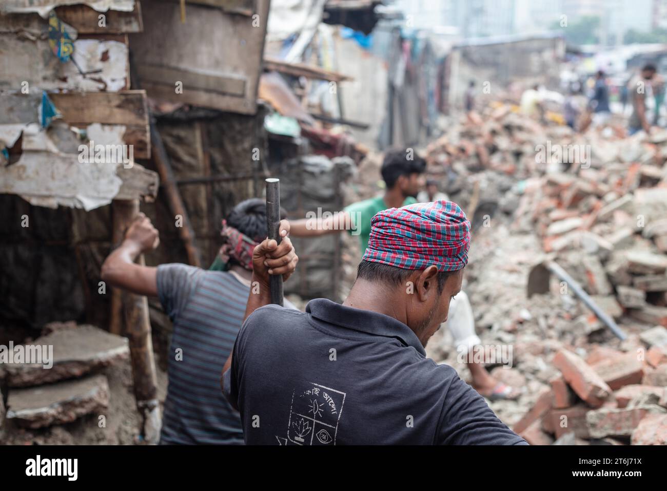 Construction worker digging a trench at a building site, Tejgaon Slum ...