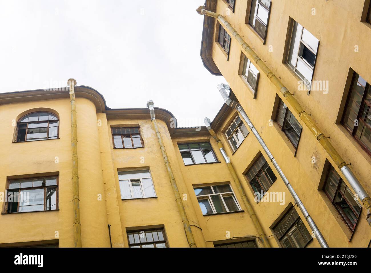 view of the upper floors of vintage buildings from the narrow and deep ...