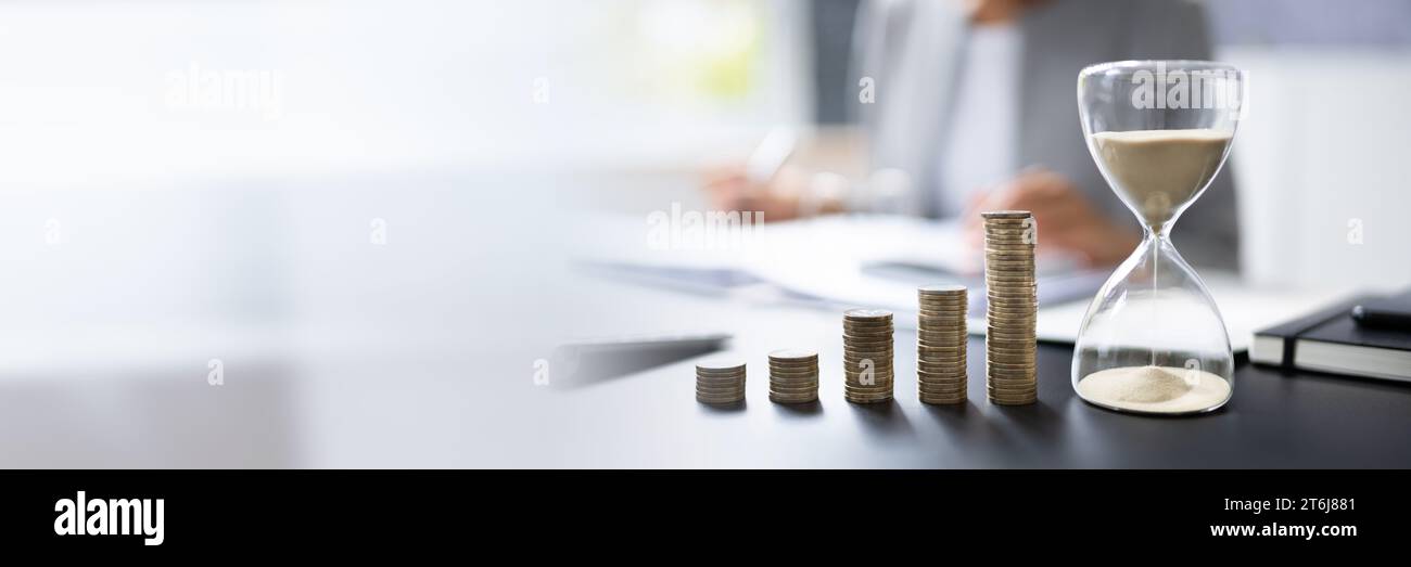Save Time and Money: Pay Inflation with Coin Hourglass Stock Photo - Alamy