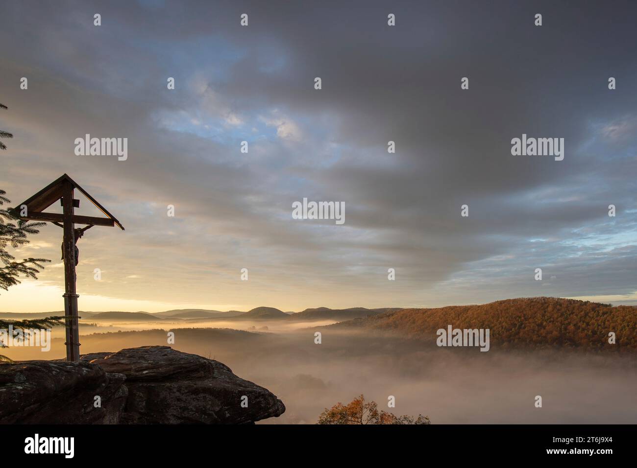 Mystical sunrise with cross at watchtower rock. Fascinating landscape ...